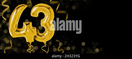 number forty three, gold foil balloon number on a blue velvet ...