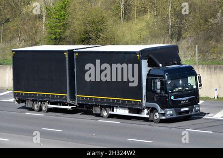 Front & side view of tow trailer & unmarked hgv flatbed lorry truck ...