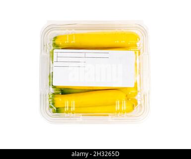 Fresh yellow zucchini packaged for sale in the market on a white ...