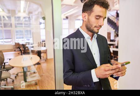 employee reads a text message on smartphone Stock Photo - Alamy