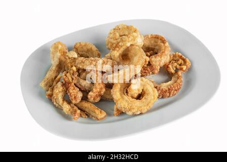 pork scratching or pork crackling on dish on dish over white background ...