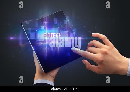Businessman holding a foldable smartphone with PRIVACY ALERT ...