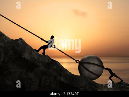 Man Pull Uphill A Big Rock With Chain In Front Of Sunset . Person male ...