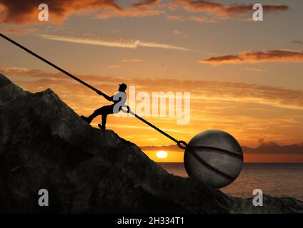 Man Pull Uphill A Big Rock With Chain In Front Of Sunset . Person male ...