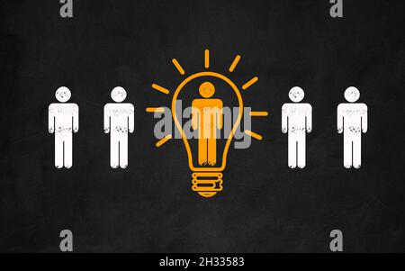 Man Inside glowing Light Bulb standing Out from the Crowd. talent and ...