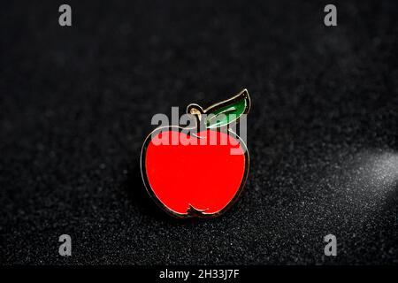 Red apple pin badge on white background Stock Photo - Alamy