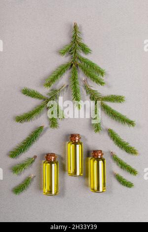 Bottles of fir tree oil and green cones on wooden table Stock Photo - Alamy