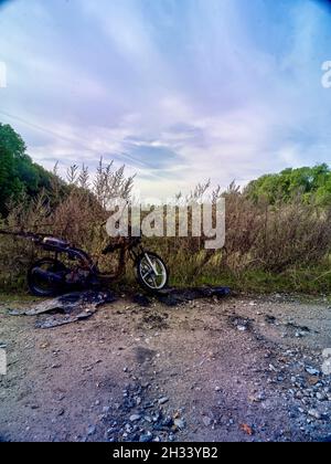 Burned out bike dumped onto recreational land, environmental pollution ...