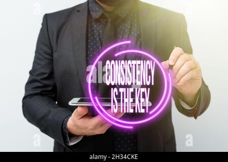 Hand writing sign Consistency Is The Key. Word Written on by Breaking ...