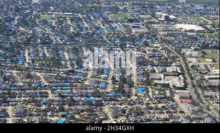 Aerial view of blue FEMA tarps on houses in the wake of Hurricane ...