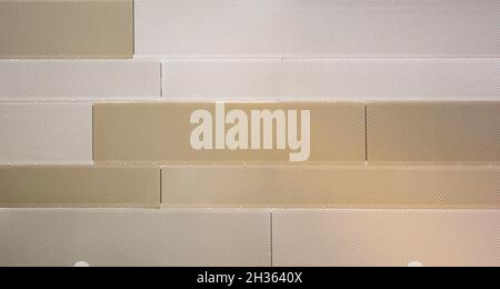 Beige sheet metal wall with holes in a close-up view. Exterior of ...