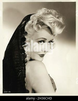 Photograph of a beautiful blond woman with a vintage or retro apearance ...