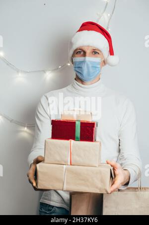 man in mask with gift at christmas tree at home Stock Photo - Alamy