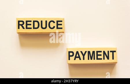 Wooden blocks with the words Reduce payment. Business concept Stock ...