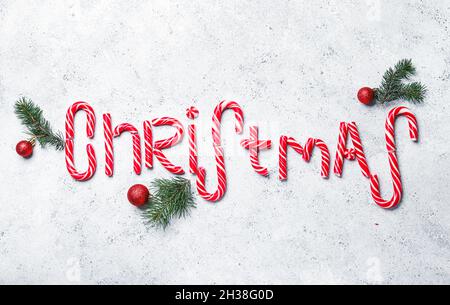 Word SANTA made of sweet candy canes and hats on color background Stock ...