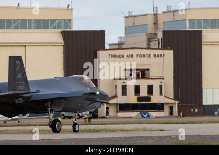 An F-35 Lightning II aircraft taxis in front of the Tinker Air Force ...