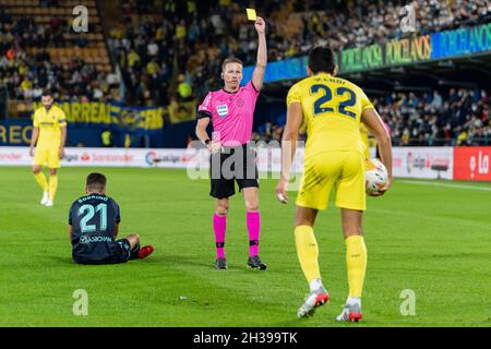 Referee Alejandro Hernandez, of Spain, right, shows a yellow card to ...