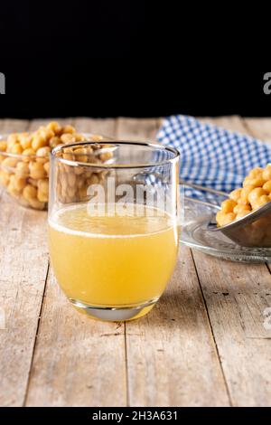 Chickpea water aquafaba on wooden table. Chickpea water is a substitute ...