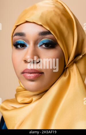 pretty muslim woman in yellow hijab posing with crossed arms isolated ...