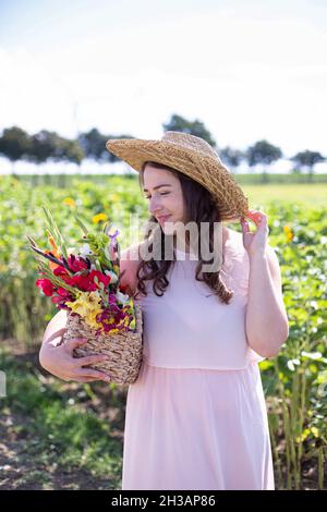 Woman rural basket hat colorful traditional dress field tree nature ...