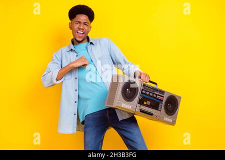 Photo of charming funny dark skin man wear denim shirt smiling isolated ...