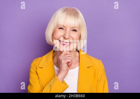 Photo of cheerful minded person finger touch temple look empty space ...