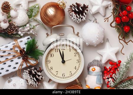 Alarm clock with Christmas balls and fir branches on dark wooden ...