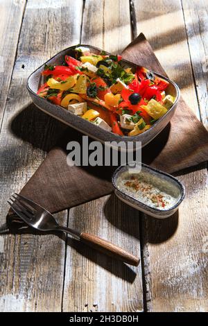 pile of black olives with fresh parsley on wooden cutting board Stock ...