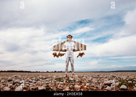 Male in silver outfit and monkey mask standing with jetpack on rocky ...