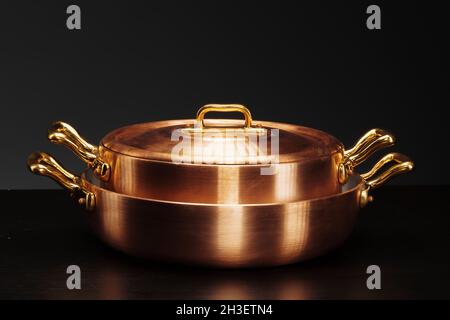 Set of copper cookware over dark background Stock Photo - Alamy