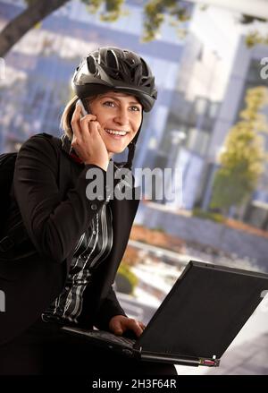 trendy businessWoman working outside sitting on round decorative panel ...