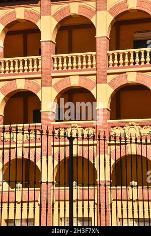Red and yellow front facade of the Bullring in Mérida, Extremadura in ...