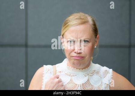 Woman glaring at camera, close-up Stock Photo - Alamy
