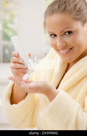 Attractive woman using body lotion. All on white background Stock Photo ...