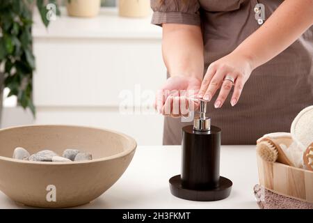 Female hands using liquid soap isolated on white Stock Photo - Alamy