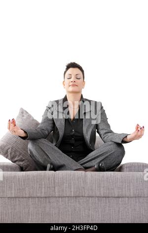 Young businesswoman meditating on the white Stock Photo - Alamy
