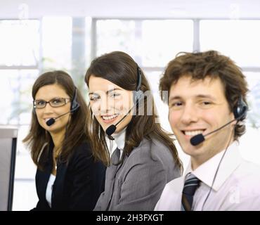 Busy call center operators in a modern office Stock Photo - Alamy