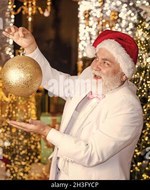 Christmas spirit. Kind grandpa with toy. Sparkling decorations ...