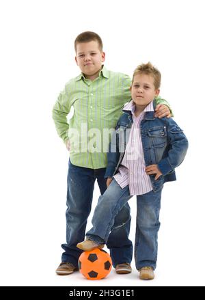 Portrait of two lovely positive brothers cuddle empty space ad blank ...