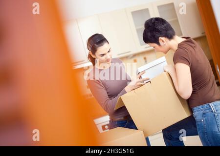 Photo of two joyful beautiful women smiling and holding map while ...