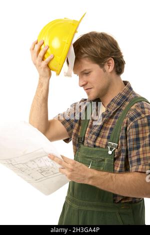 Builder looking at a technical drawing Stock Photo - Alamy
