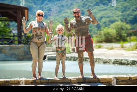 A happy family takes a mud bath at a resort in Turkey.Family wellness in therapeutic mud Stock ...