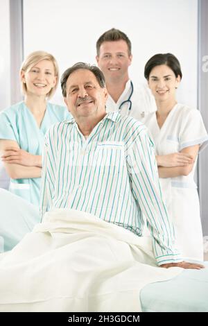 Medical team and patient smiling Stock Photo - Alamy