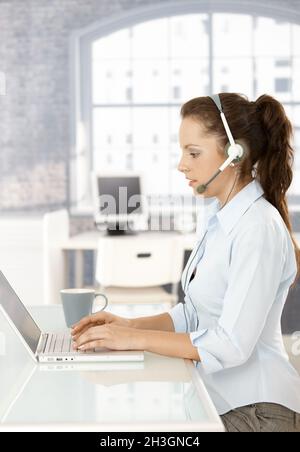 Young dispatcher working in bright office Stock Photo - Alamy