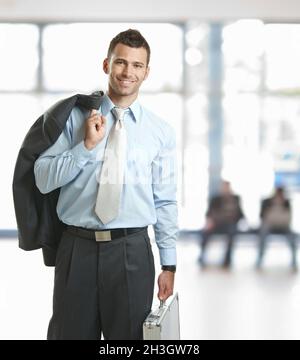Happy caucasian businessman leaving the office jumping in the air ...
