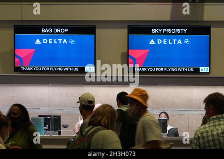 Passengers at Delta Airlines ticket baggage drop counter at the ...