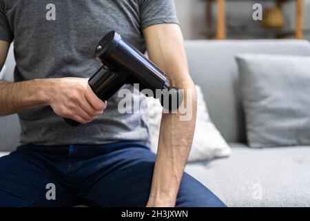 Massage Gun Muscle Pain Recovery Using Machine Stock Photo - Alamy