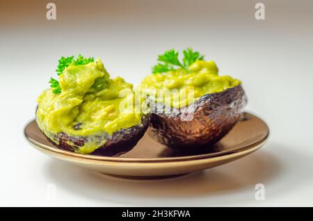 Smashed avocado, smother avocado with lemon juice served on the for ...