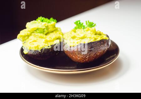 Smashed avocado, smother avocado with lemon juice served on the for ...