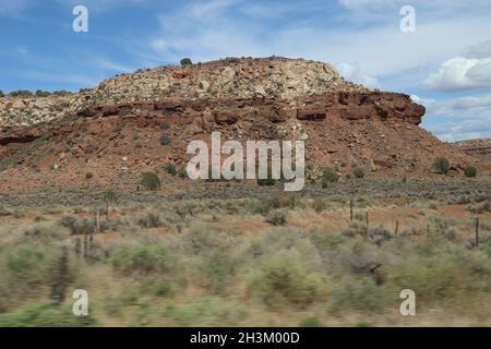 Mesa among rugged layered red rock dramatic desert landscape at the ...